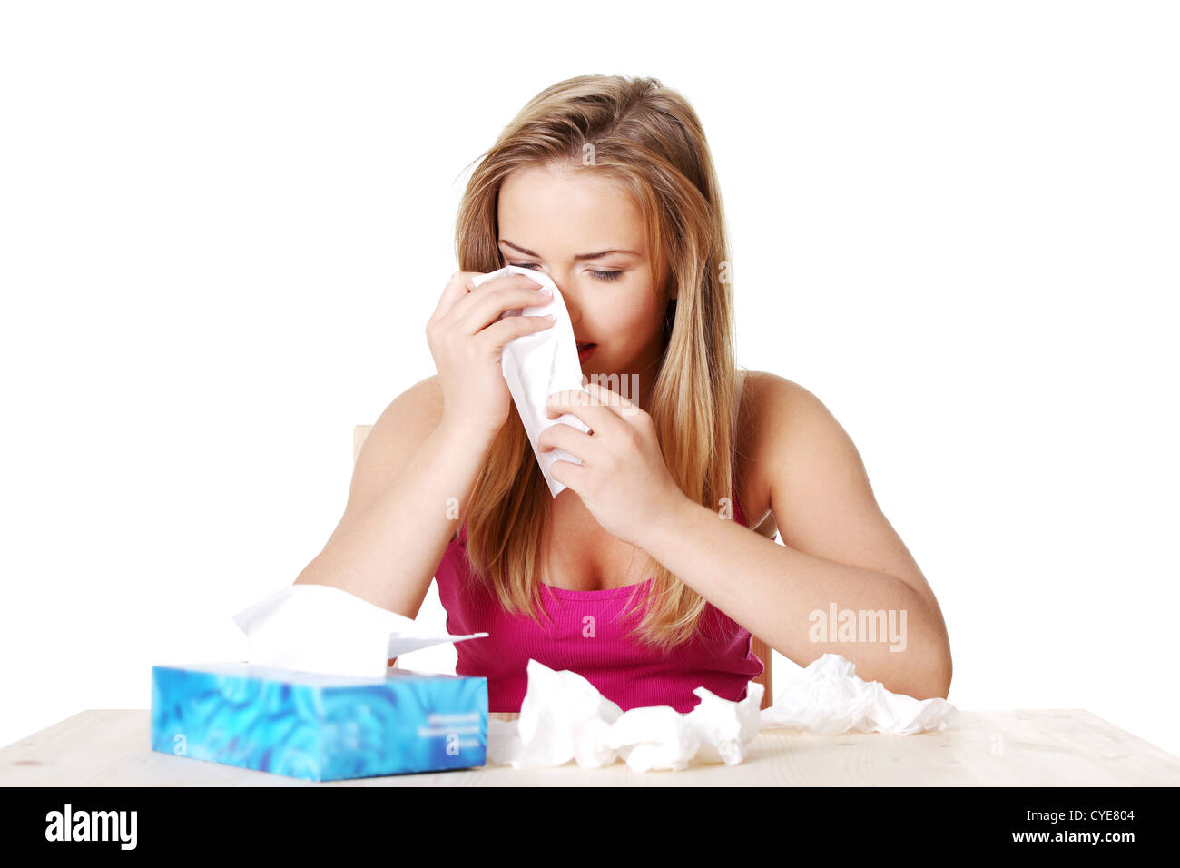 Attractive young woman using a tissue Stock Photo - Alamy