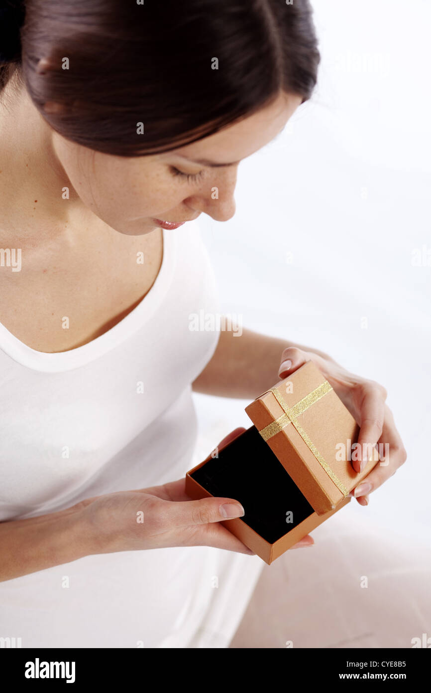Cute young woman opening gift box close-up Stock Photo - Alamy