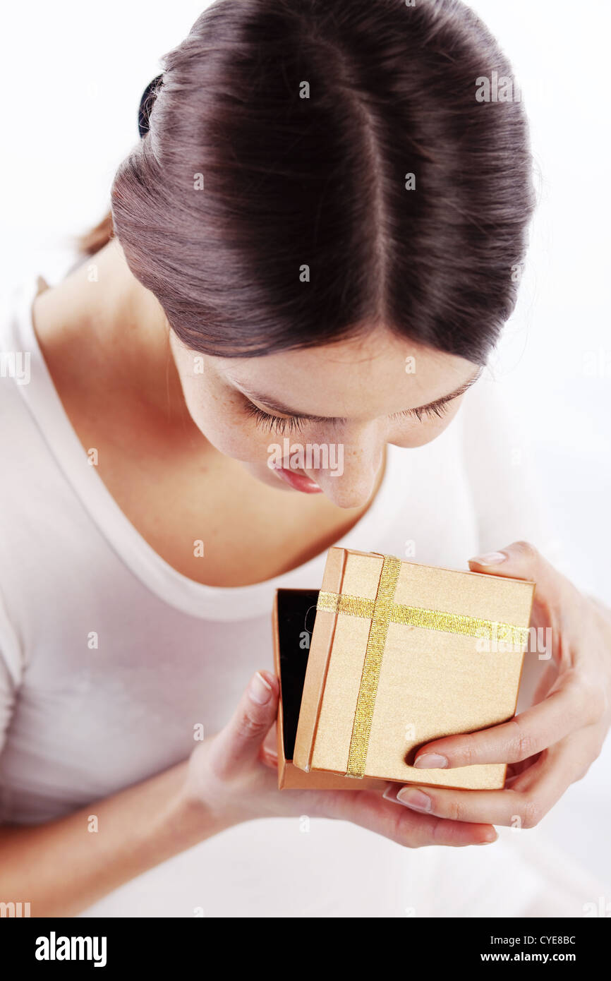 Cute young woman opening gift box close-up Stock Photo - Alamy