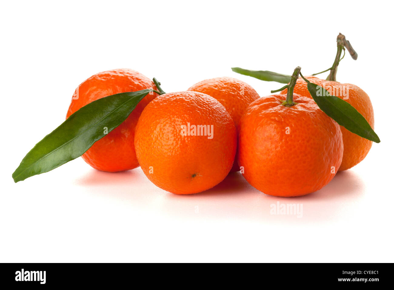 Five ripe tangerines with leafs. Isolated on white Stock Photo - Alamy
