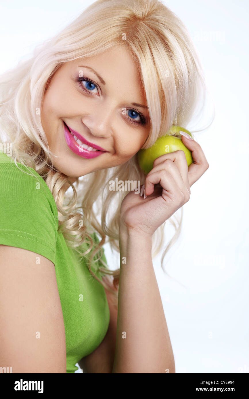 Bright portrait of very cute woman holding green apple Stock Photo - Alamy