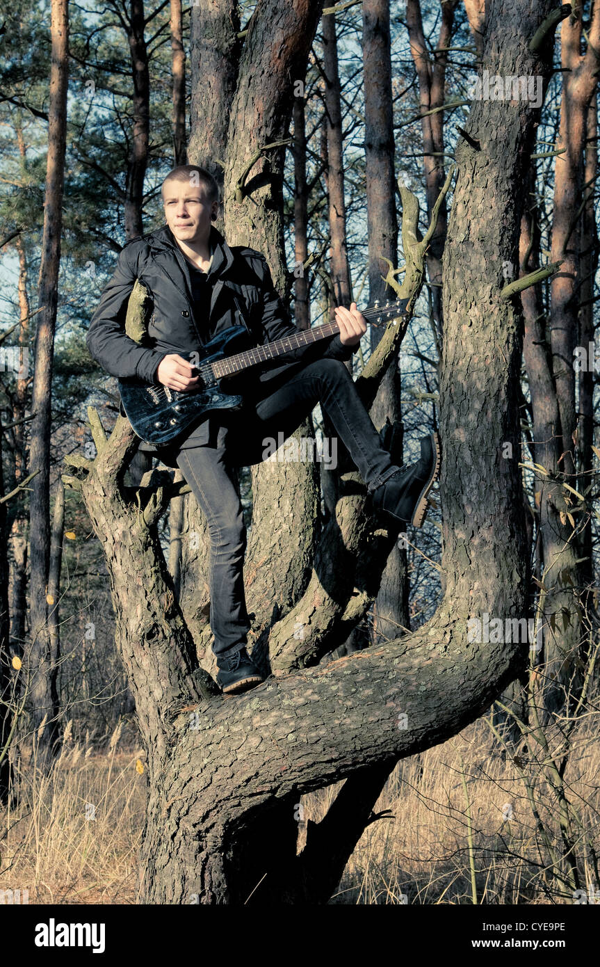 teen musician plays the guitar in the autumn forest Stock Photo - Alamy