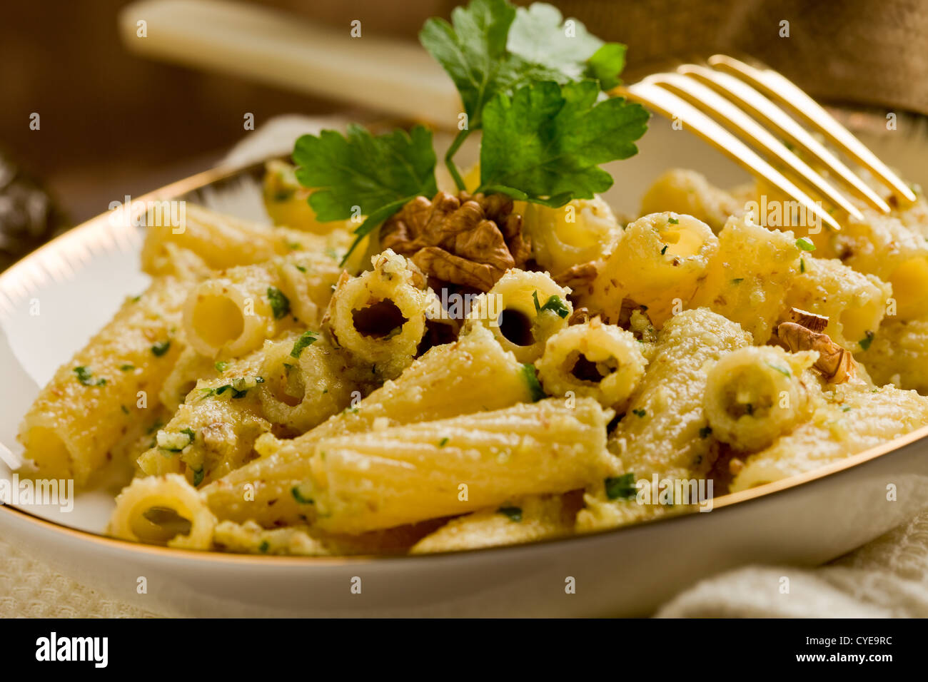 Italian regional dish made of pasta with walnut pesto on wooden table ...