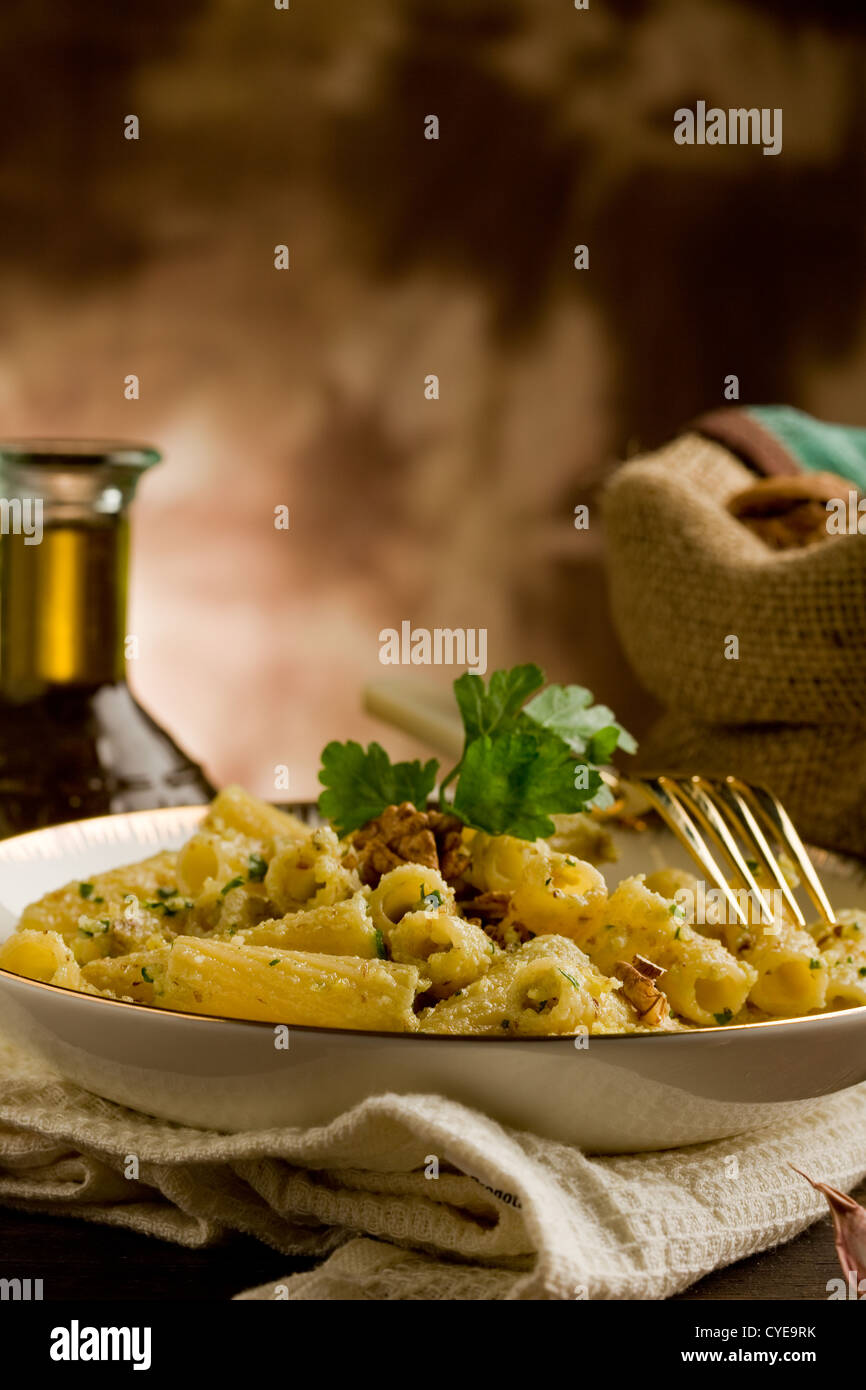 Italian regional dish made of pasta with walnut pesto on wooden table ...