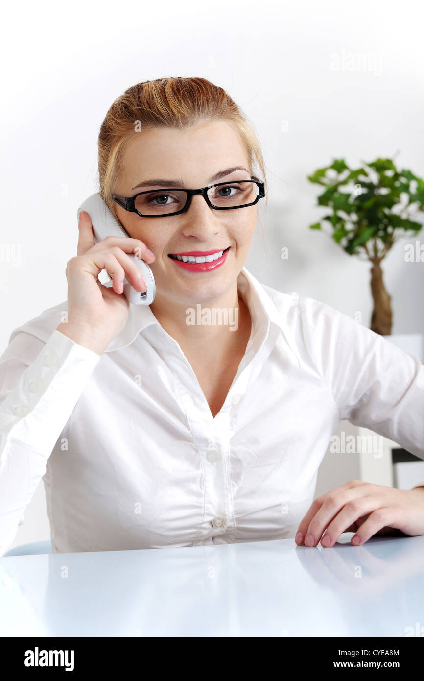Woman answering the phone Stock Photo - Alamy
