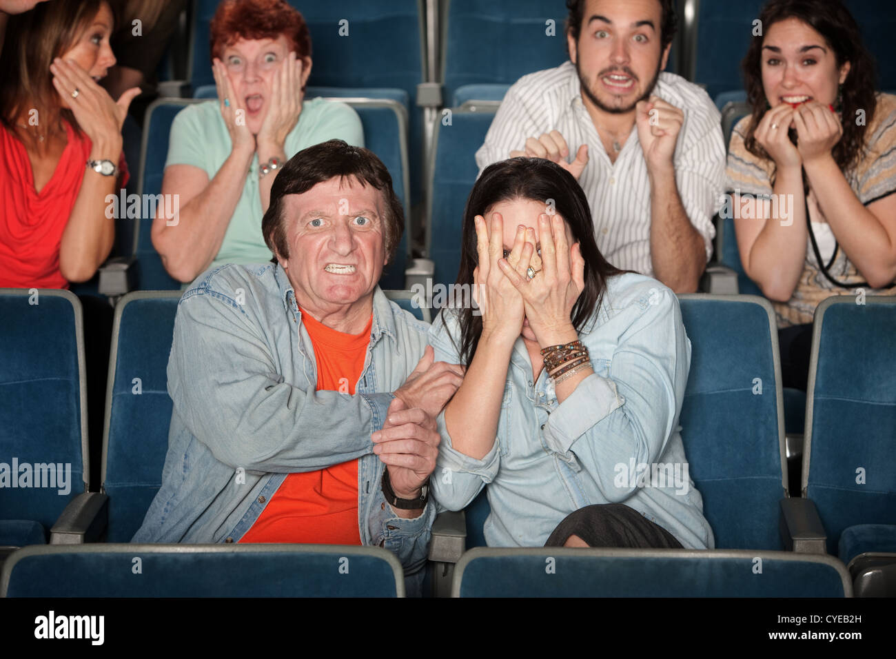 Groups of scared people in movie theater Stock Photo - Alamy