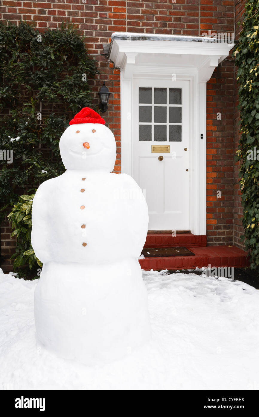 Real snowman with smile outside front door of house Stock Photo - Alamy