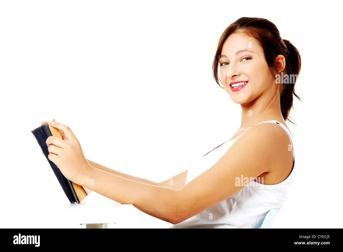 Young smiling girl holding a book in her hand and smiling Stock Photo ...