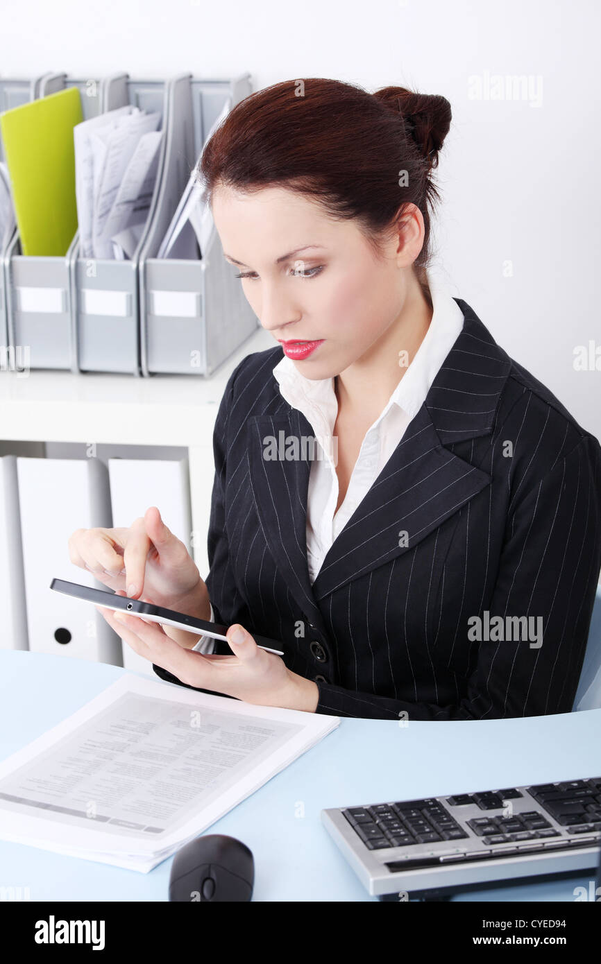 Pretty caucasian businesswoman using a tablet in the office Stock Photo ...