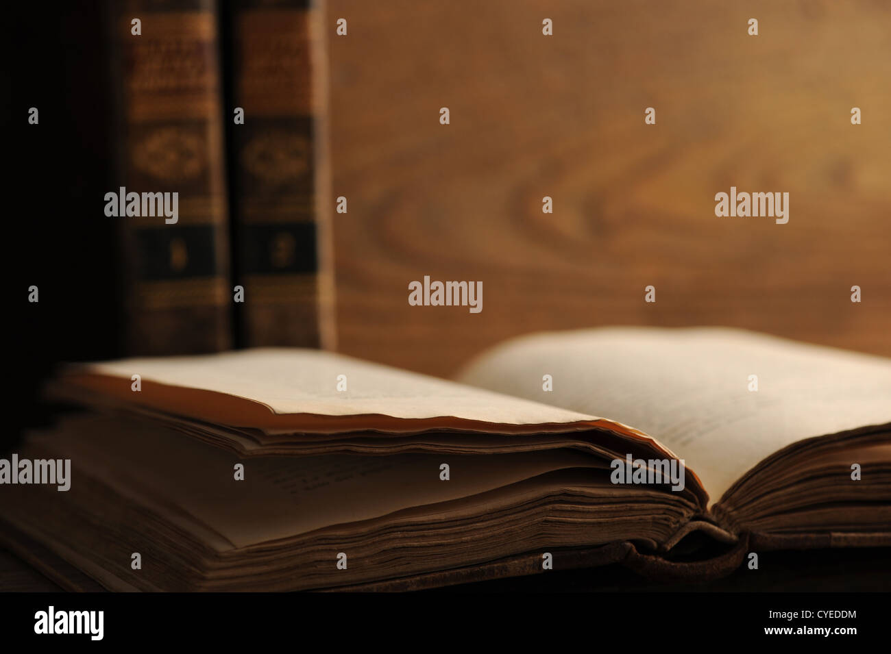 old book open on a wooden table Stock Photo - Alamy