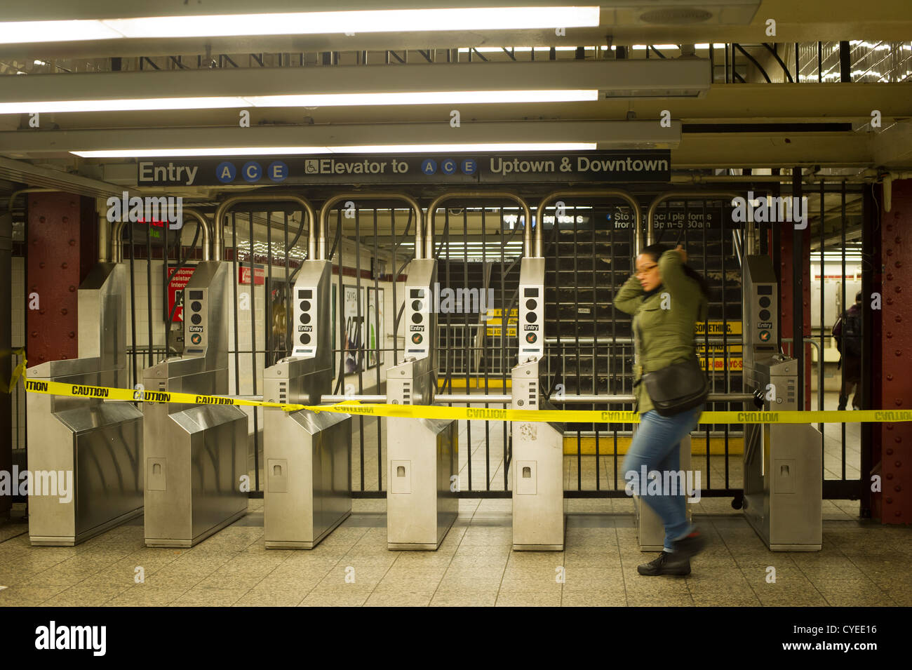 A commuter in New York passes a closed subway entrance at Penn Station ...