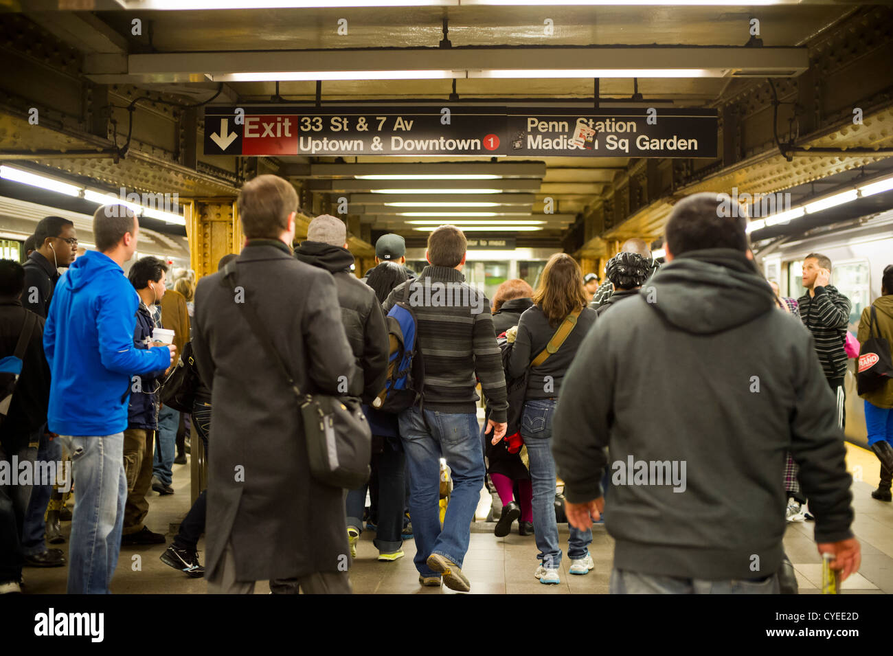 Commuters in New York arrive at Penn Station on the IRT subway line ...
