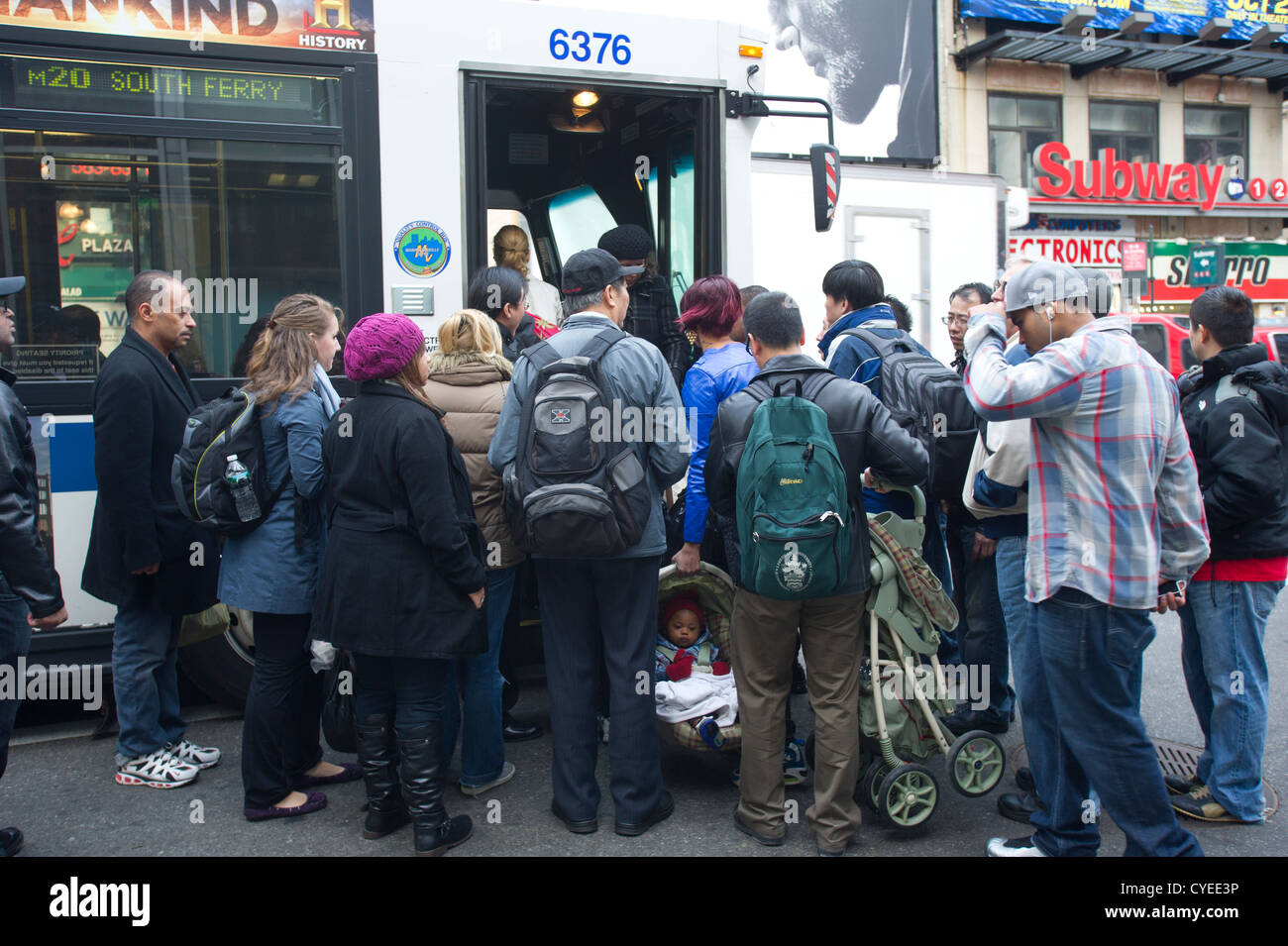Commuters in New York board buses at Penn Station Stock Photo - Alamy