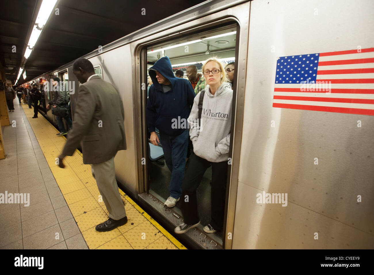Commuters in New York arrive at Penn Station on the IRT subway line ...