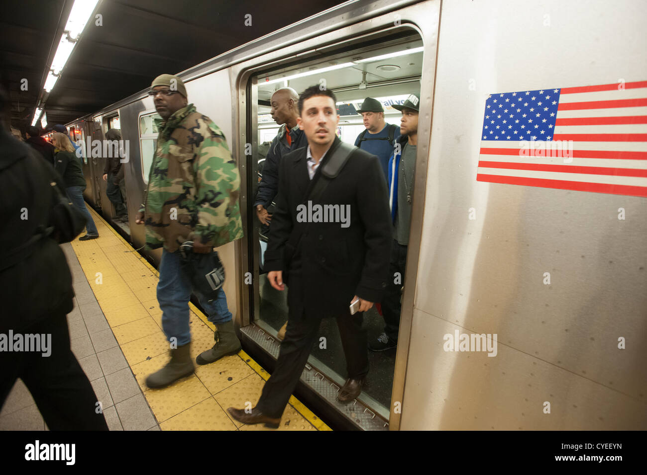 Commuters in New York arrive at Penn Station on the IRT subway line ...