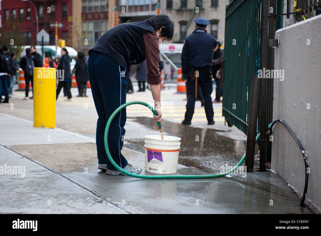 Residents without power from Hurricane Sandy fill buckets of water to ...