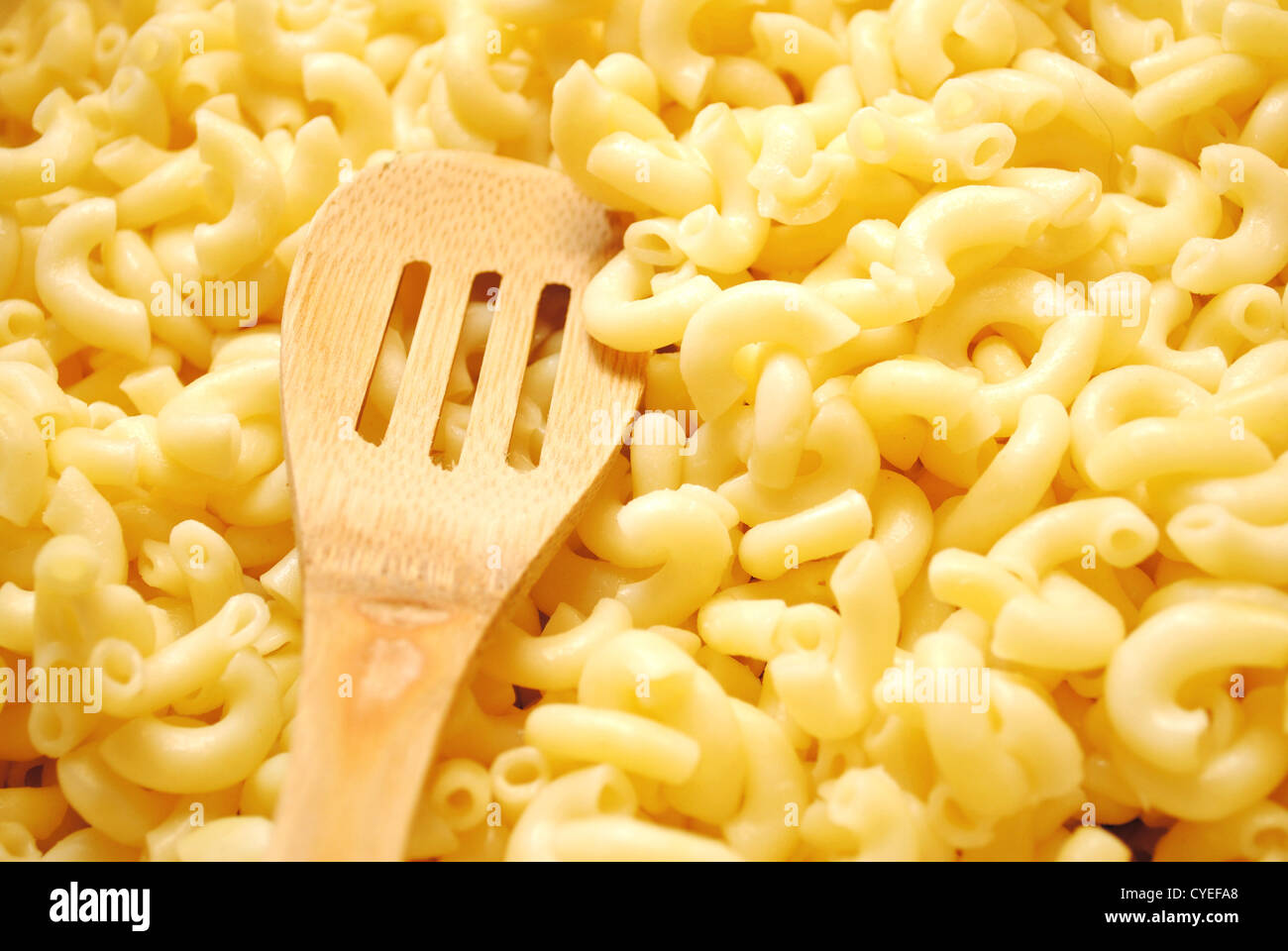 A Slotted Wooden Spoon in Cooked Elbow Macaroni Stock Photo - Alamy