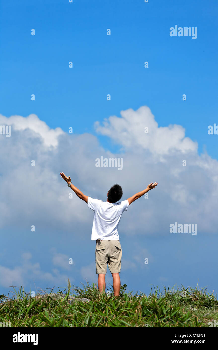 Man holding arms up Stock Photo - Alamy