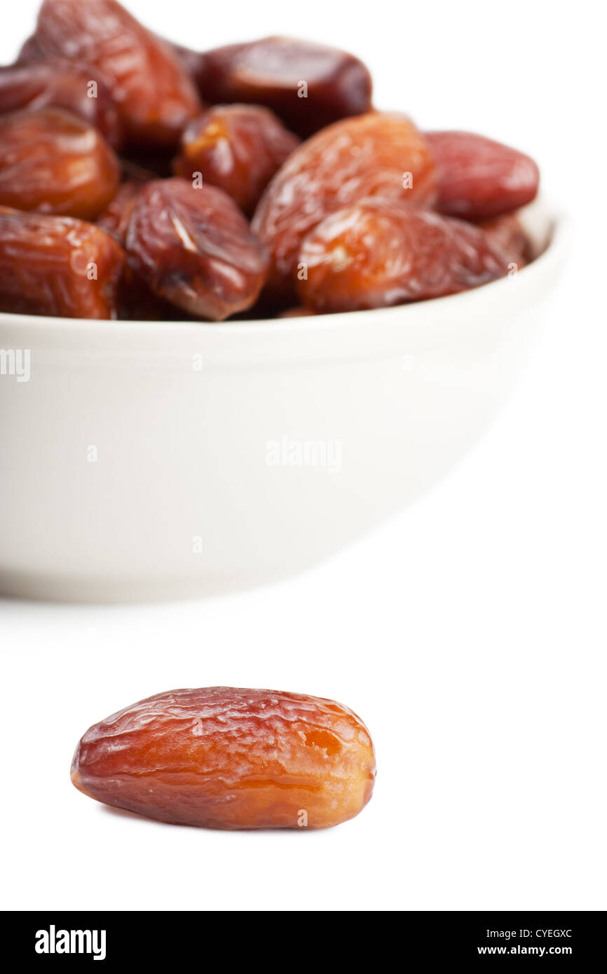 Sweet dates in a white bowl isolated over white background Stock Photo ...