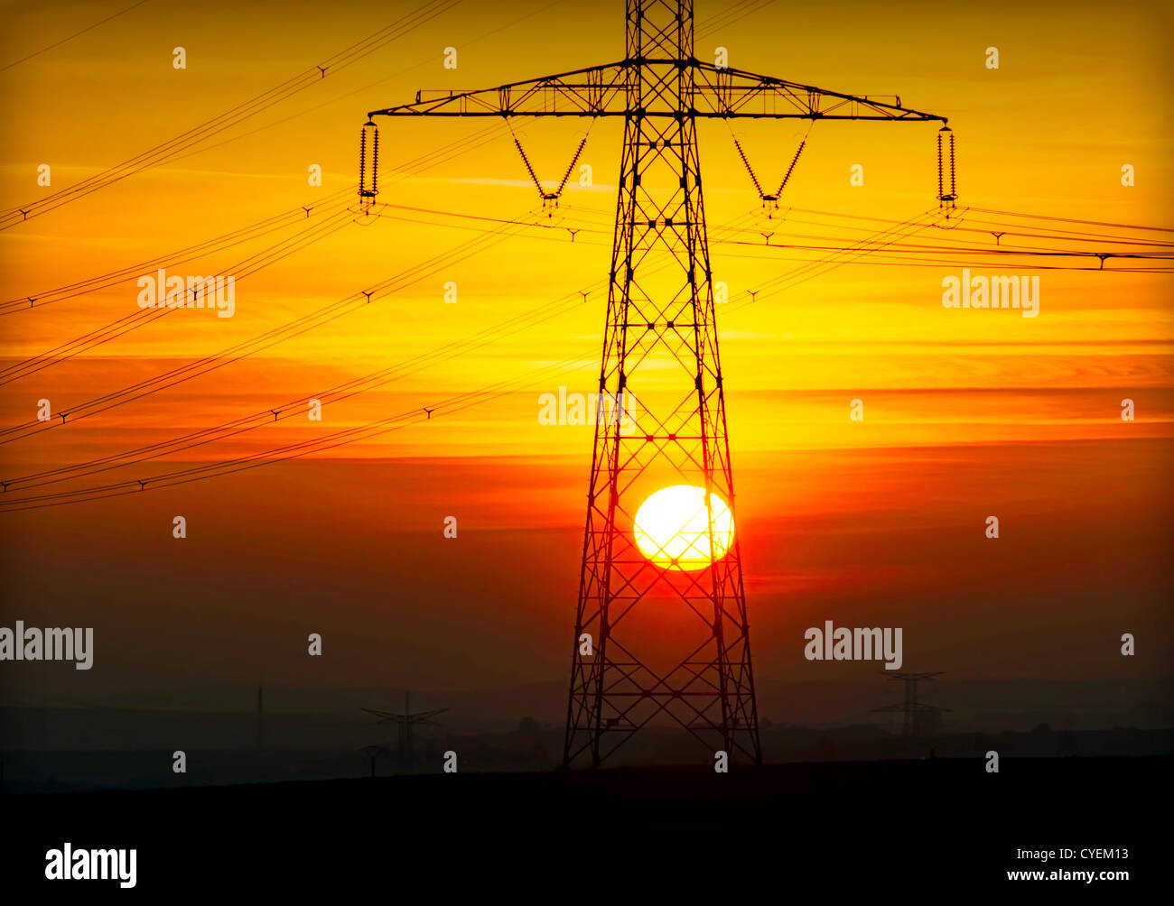 high voltage pylons on sunset background Stock Photo - Alamy