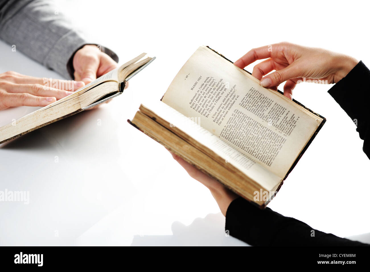 Man and woman reading an old book Stock Photo - Alamy
