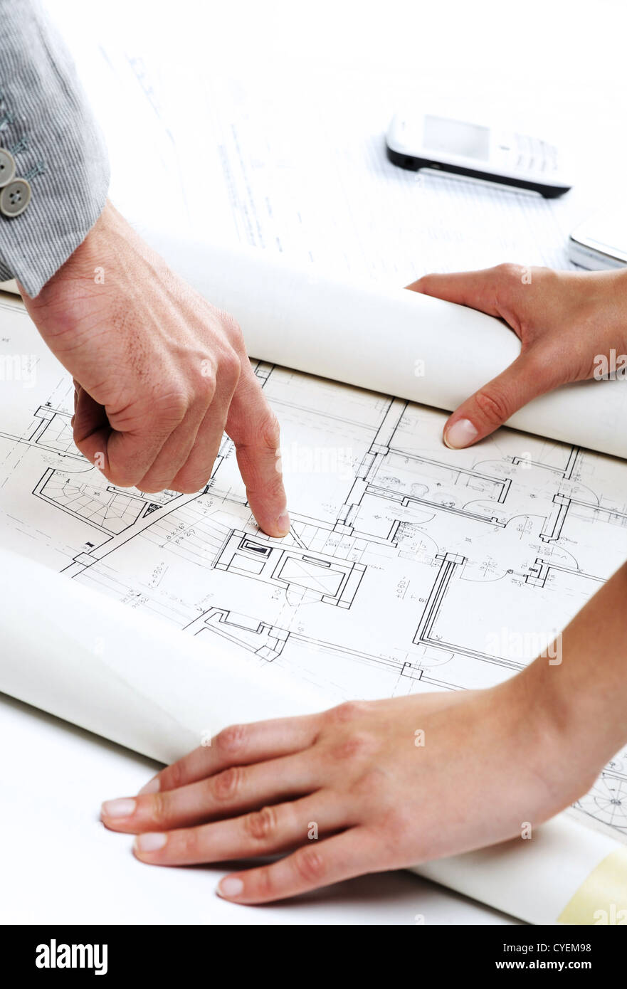 Architect´┐¢s hands pointing on the blueprint of new house project ...