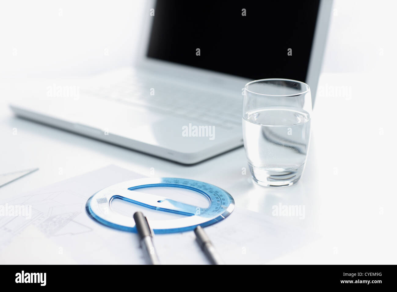 workplace, laptop and water glass on white table Stock Photo - Alamy