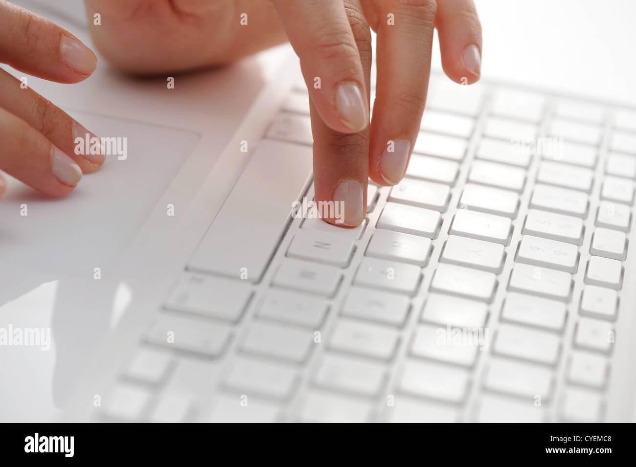 Female hands typing on a white computer keyboard Stock Photo - Alamy