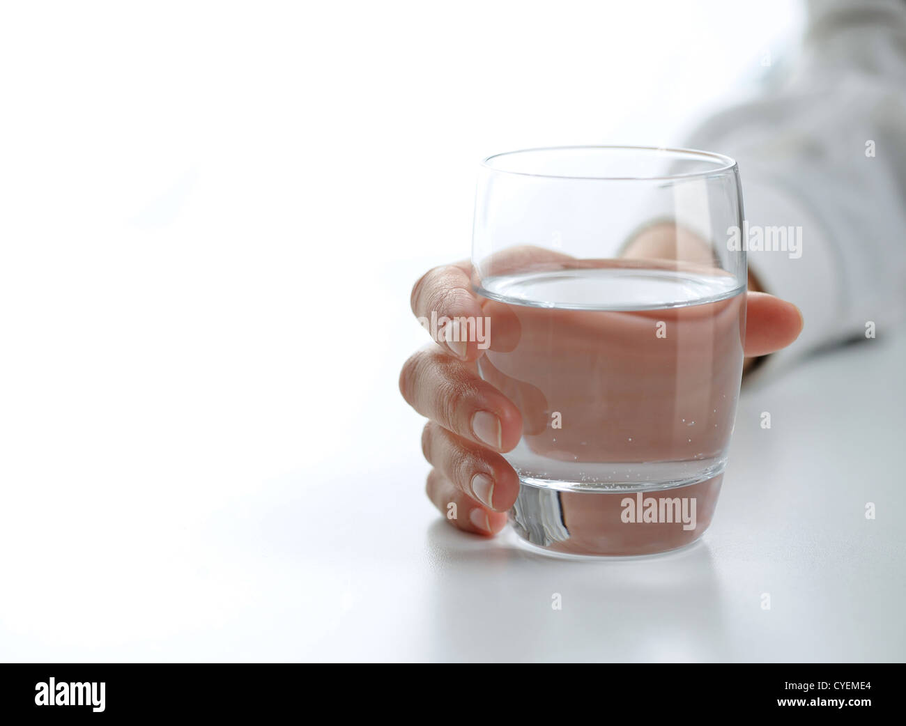 female hand with a glass of water Stock Photo - Alamy