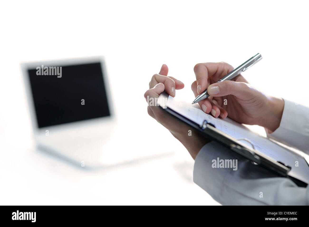 Business woman taking notes, laptop on background Stock Photo - Alamy