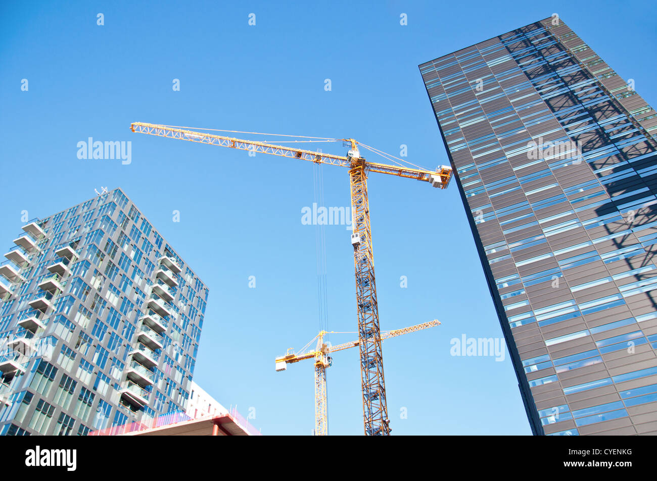 Skyscrapers with tower cranes on sky background Stock Photo - Alamy