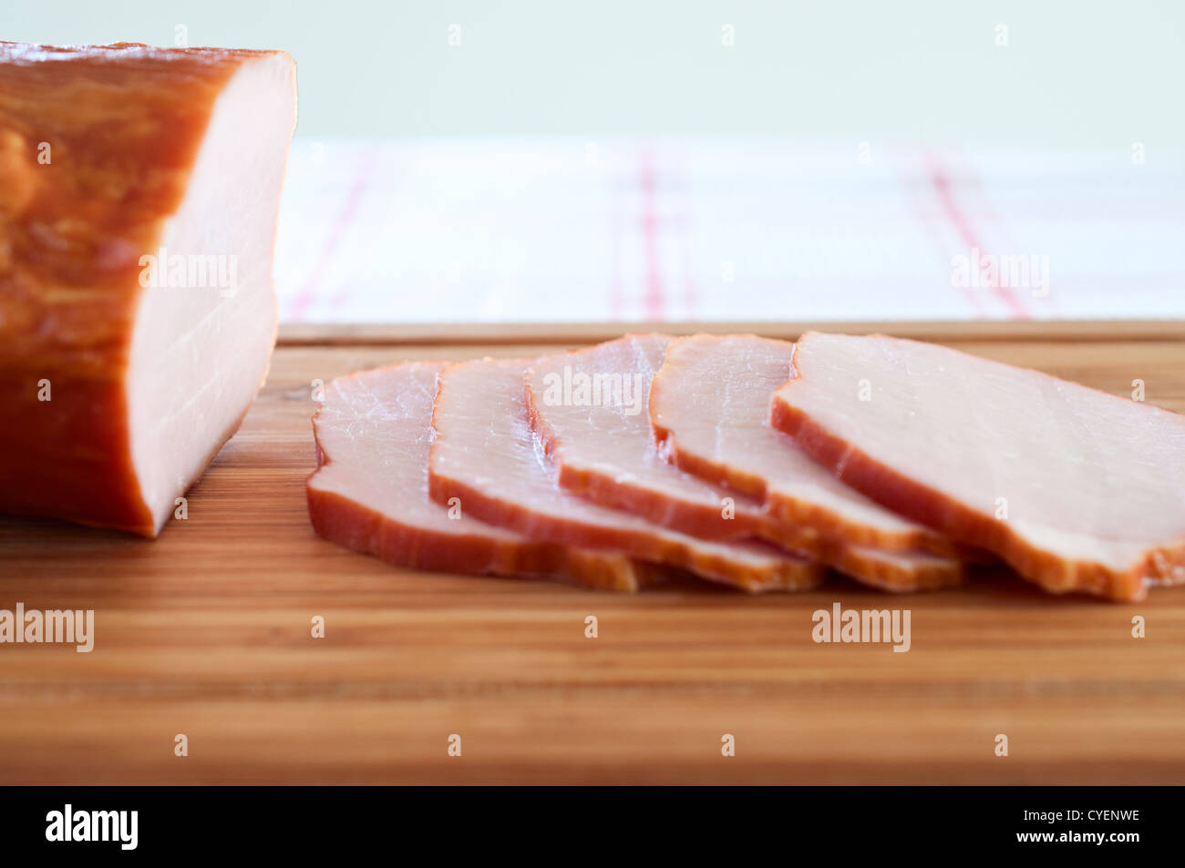 Ham cut into slices on a wooden board Stock Photo - Alamy