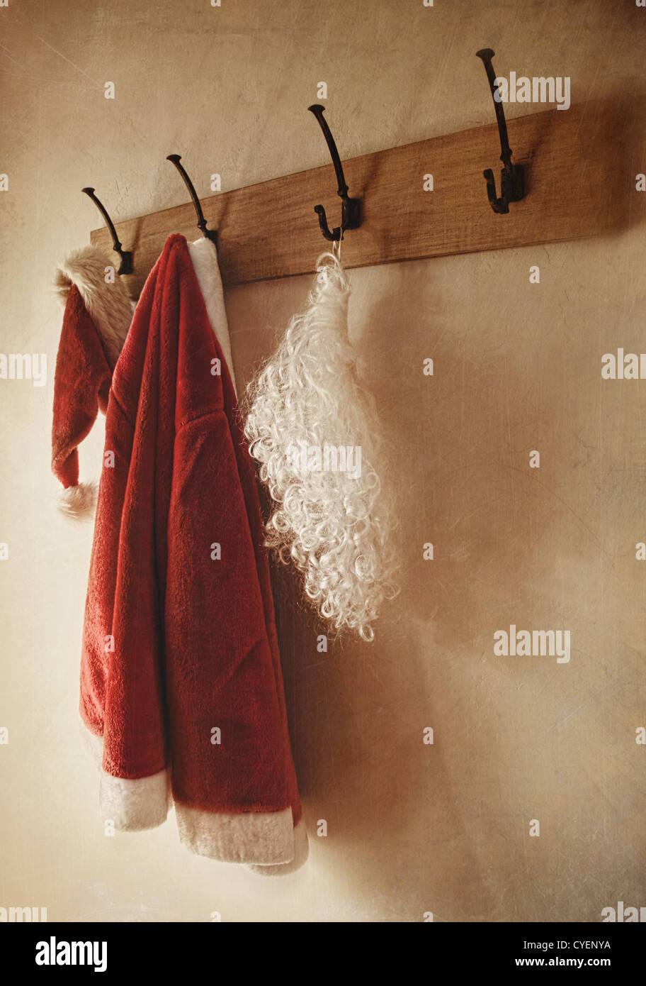 Santa costume hanging on coat rack with vintage look Stock Photo - Alamy
