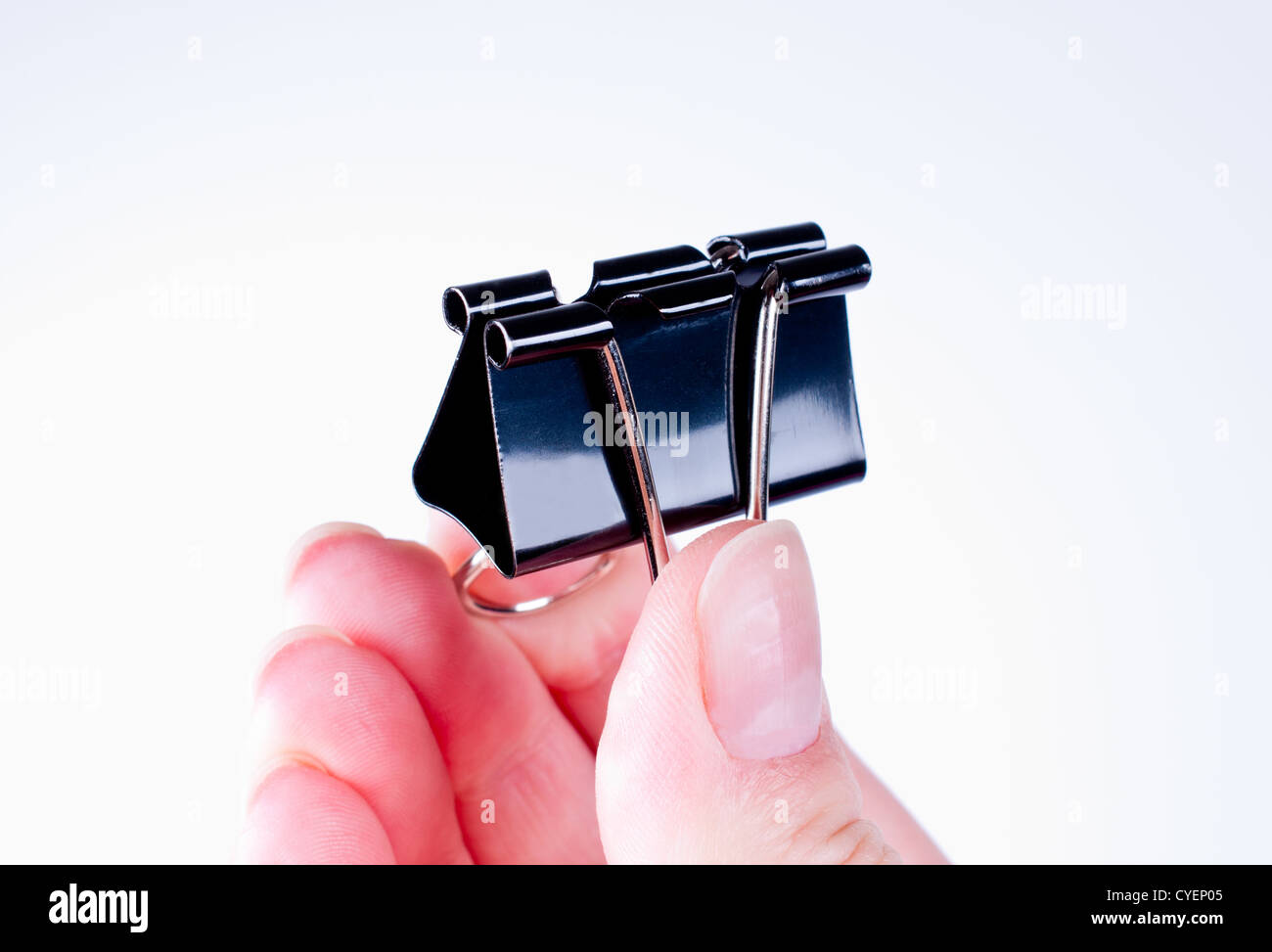 Hand holding a clip on white background Stock Photo - Alamy