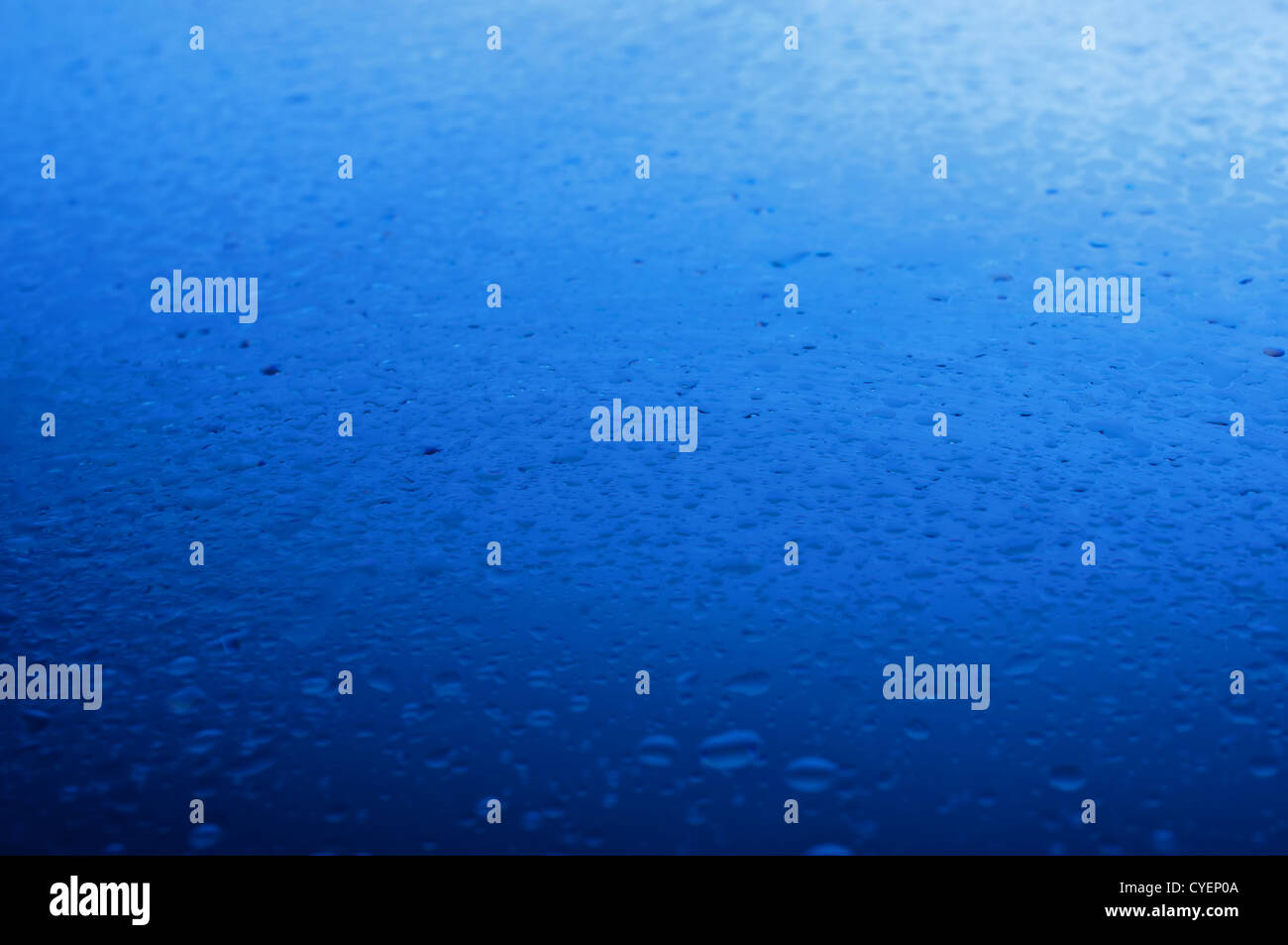 Spray water on a blue background close up Stock Photo - Alamy