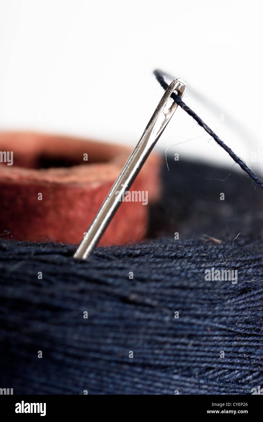 Macro view of needle and black thread Stock Photo - Alamy