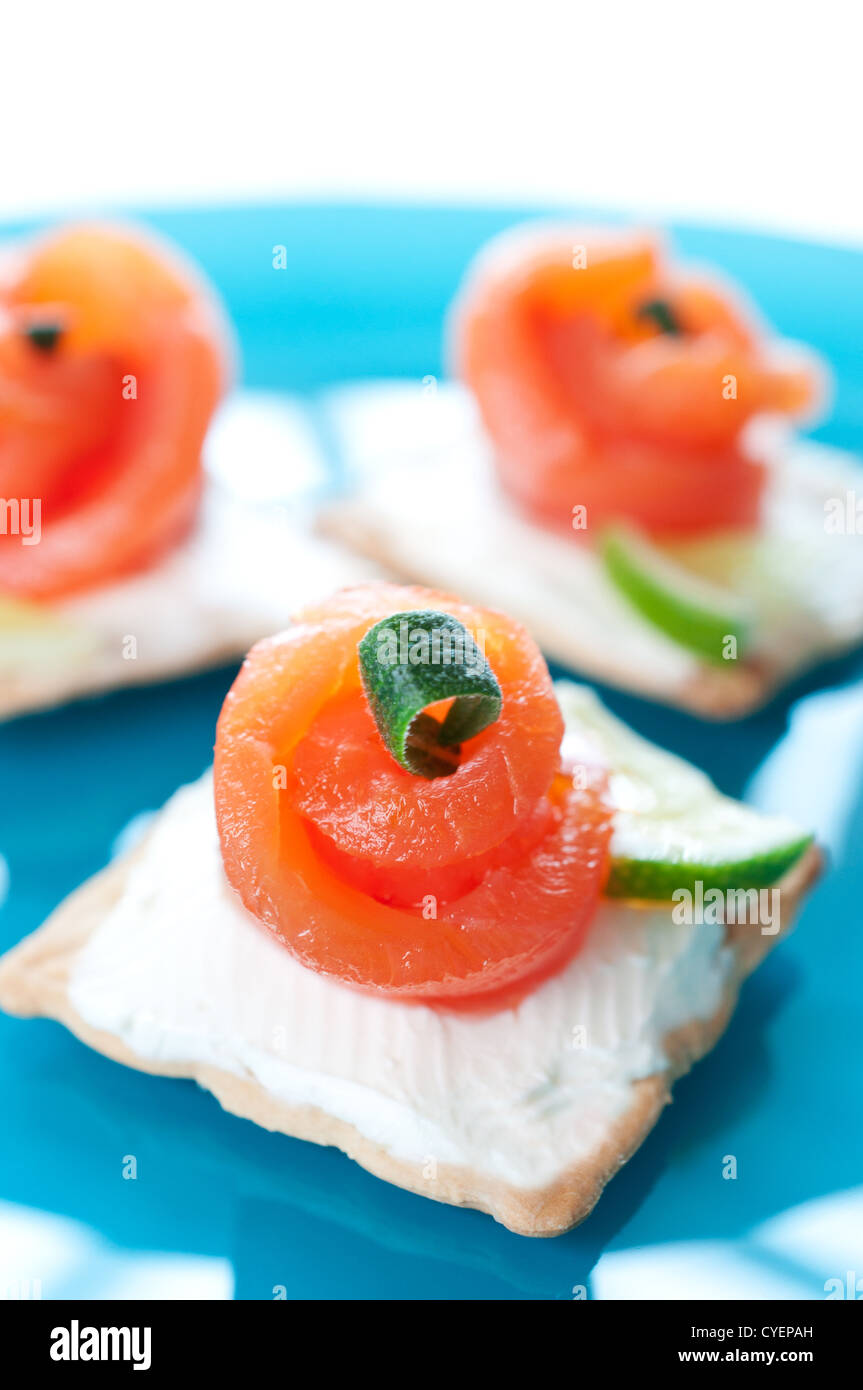 Canapes with smoked salmon and cream cheese on blue plate Stock Photo ...
