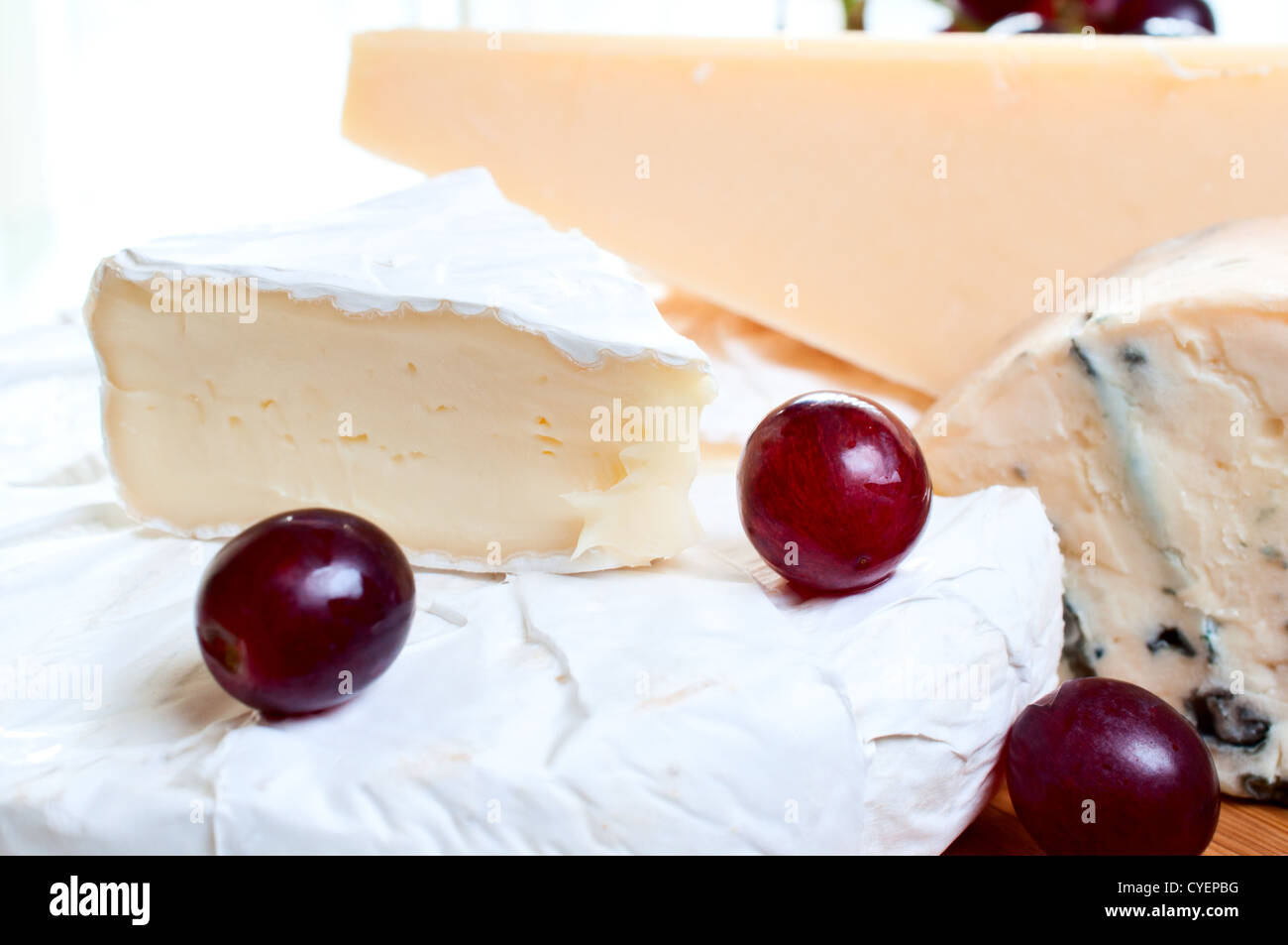 Brie parmesan and blue cheese with grape Stock Photo - Alamy