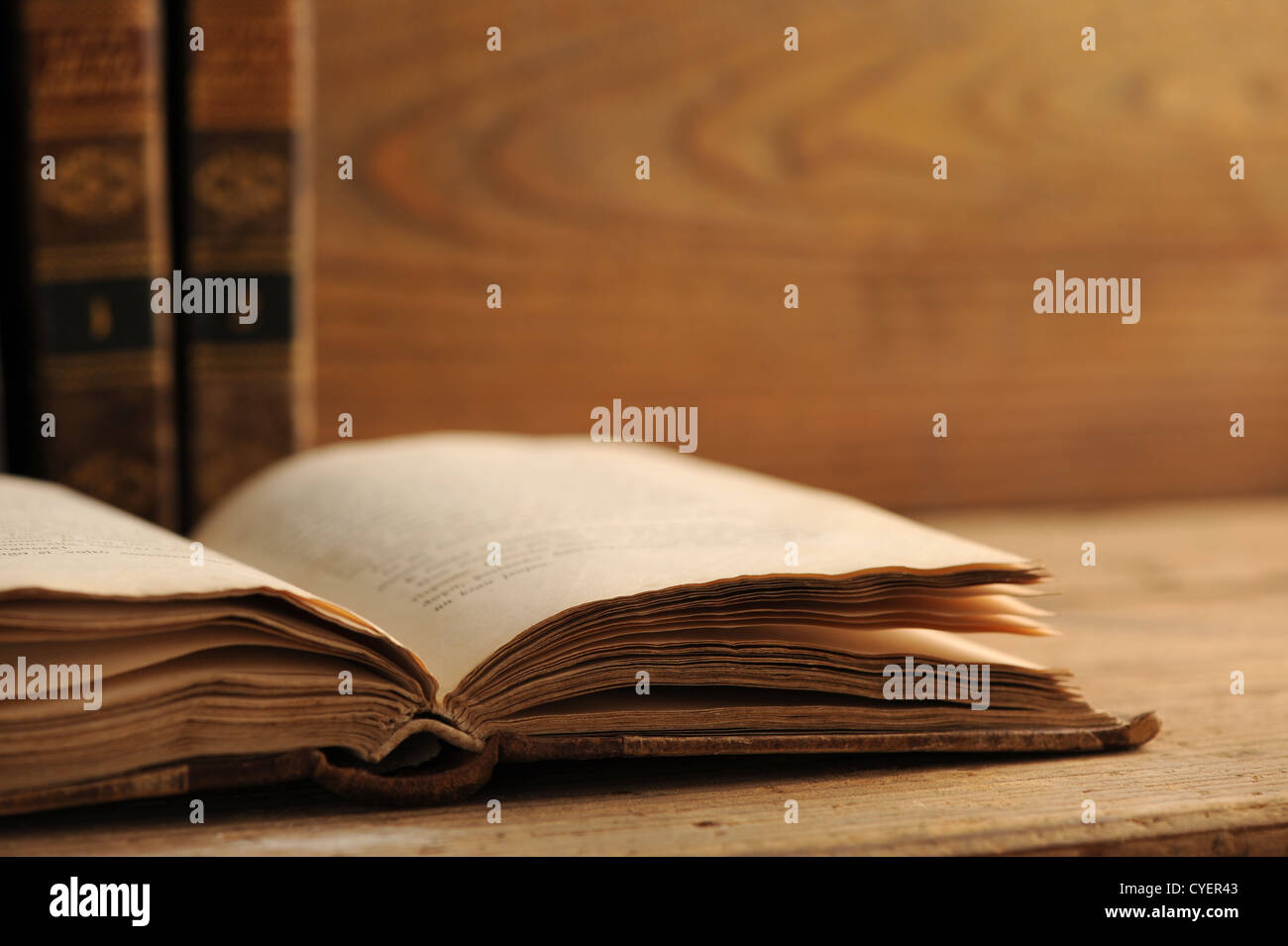 old book open on a wooden table Stock Photo - Alamy