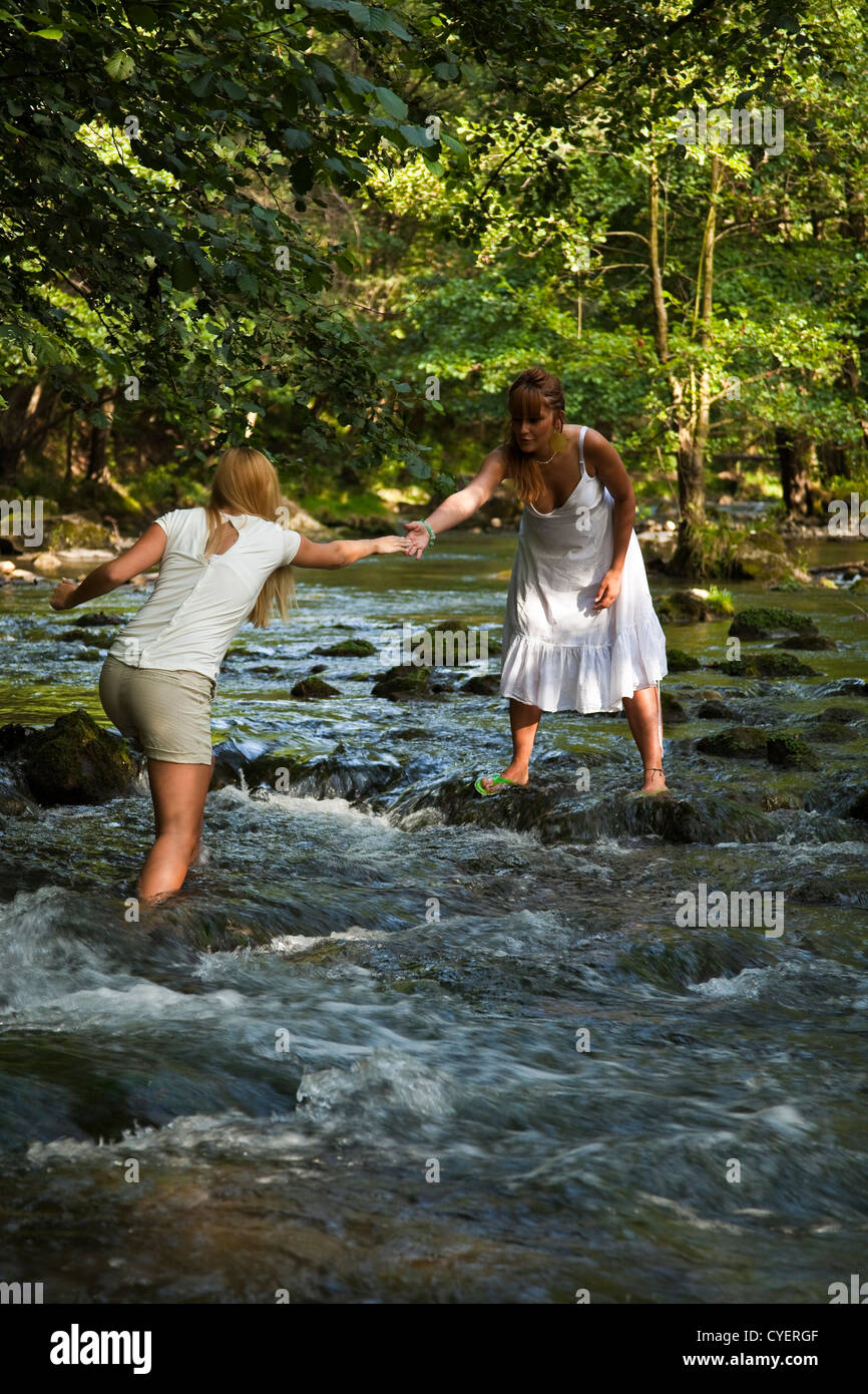 Couple crossing stream together in hi-res stock photography and images ...