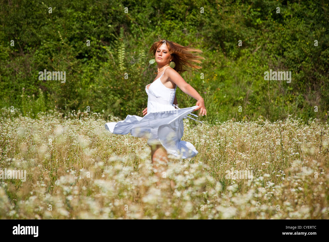 Woman In White Dress Dancing In Nature Stock Photo - Alamy