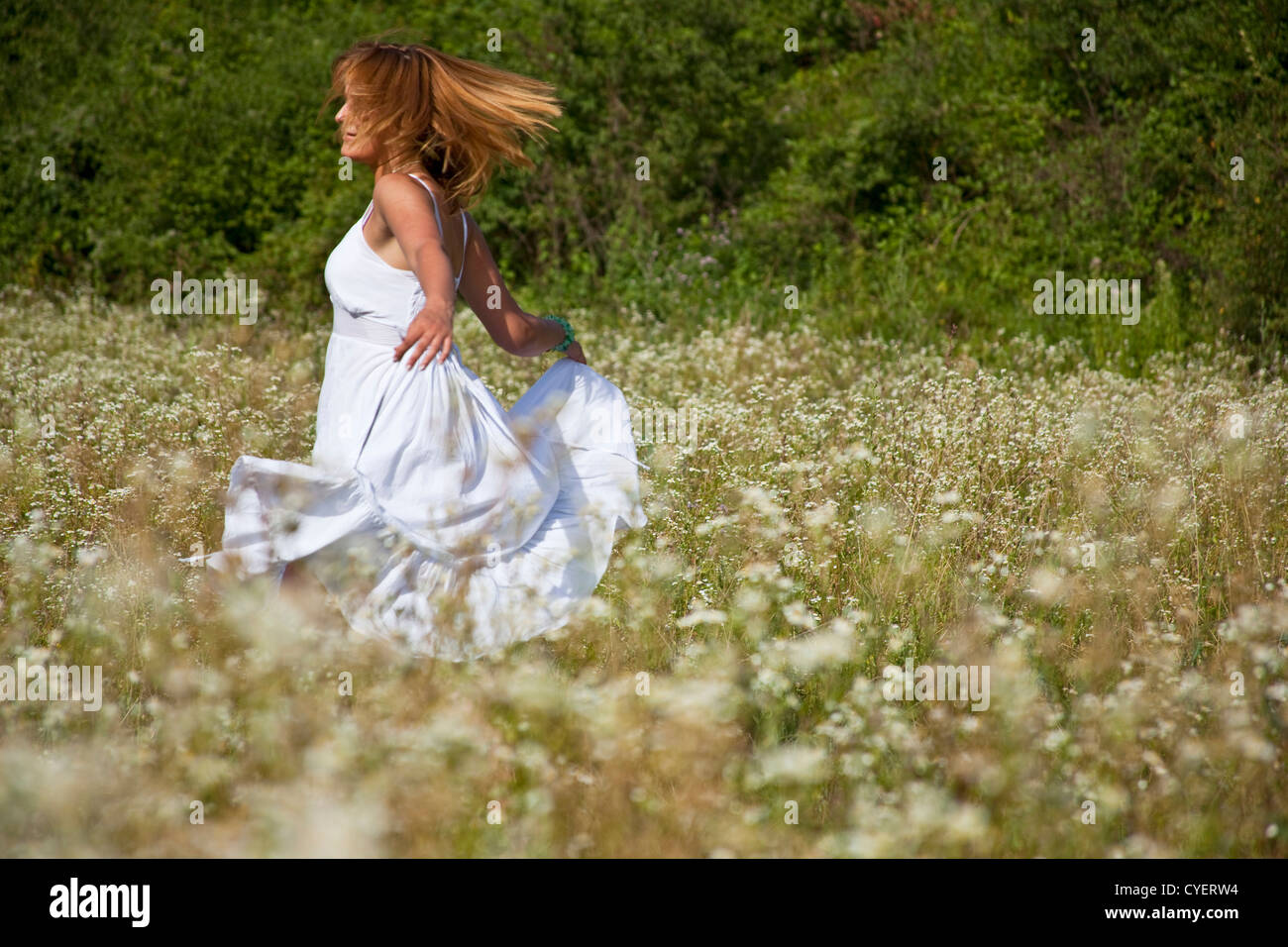 Woman In White Dress Dancing In Nature Stock Photo - Alamy