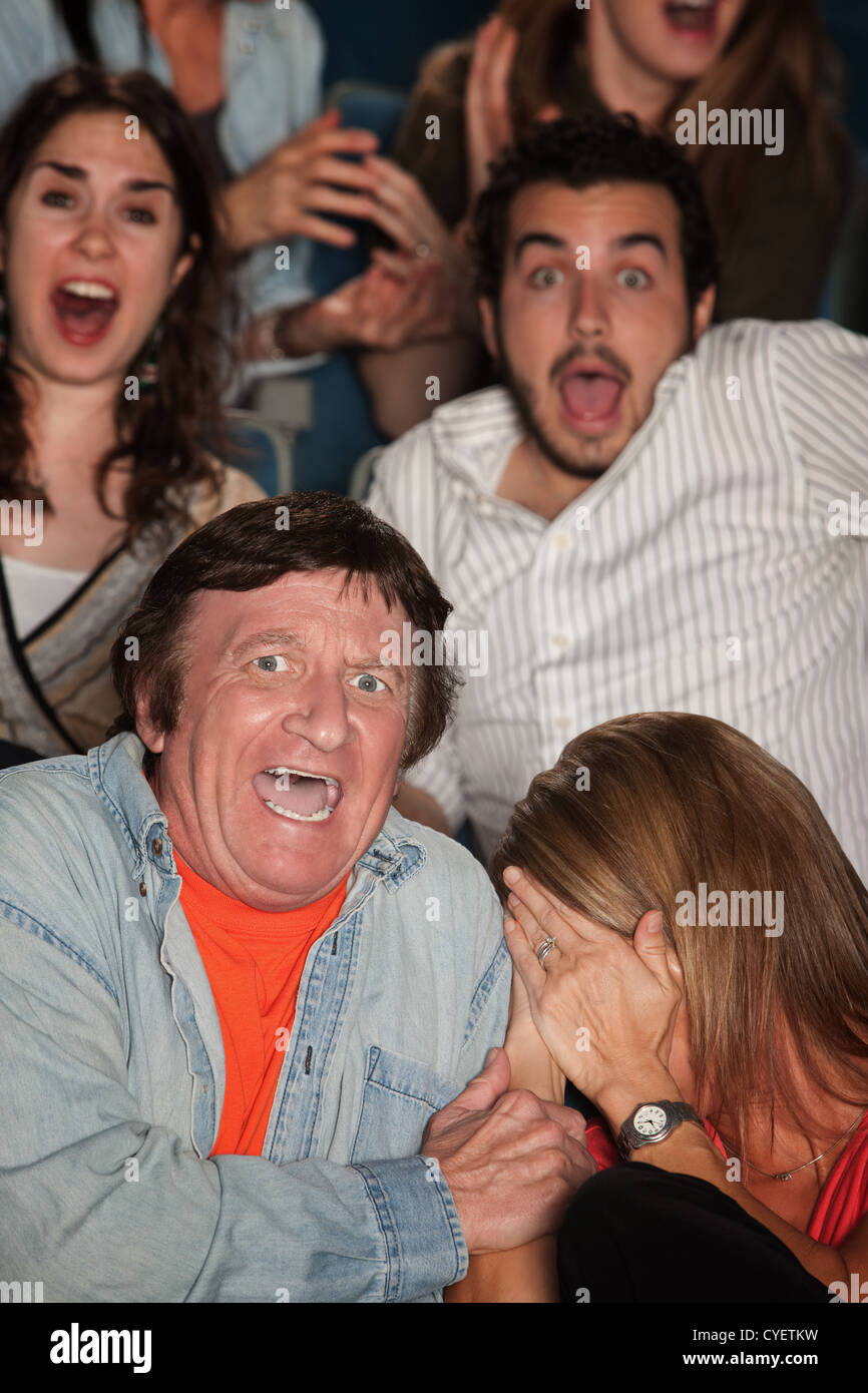 Group of people in audience react in fear Stock Photo - Alamy