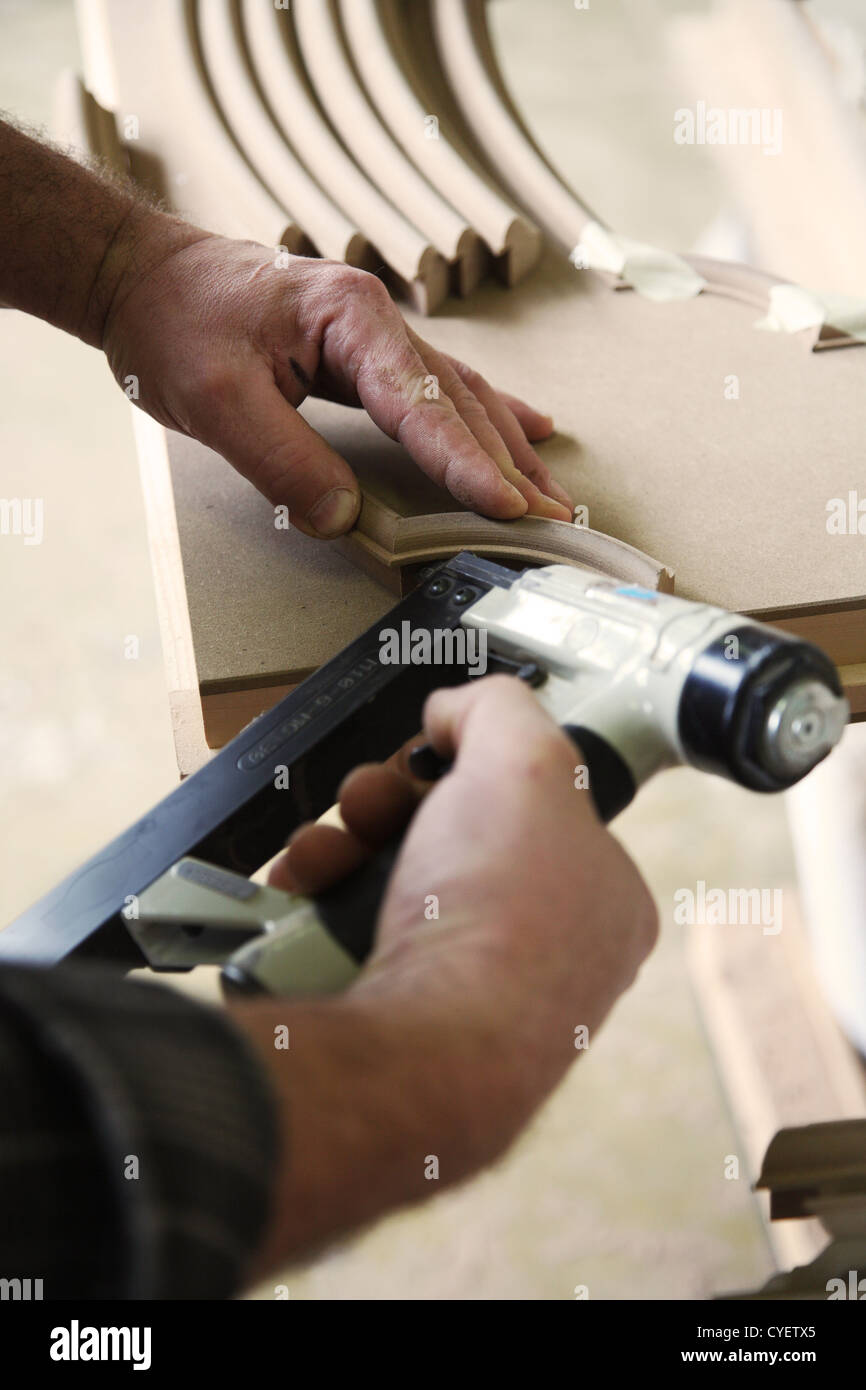 hands of a carpenter using a gun tacker air Stock Photo - Alamy