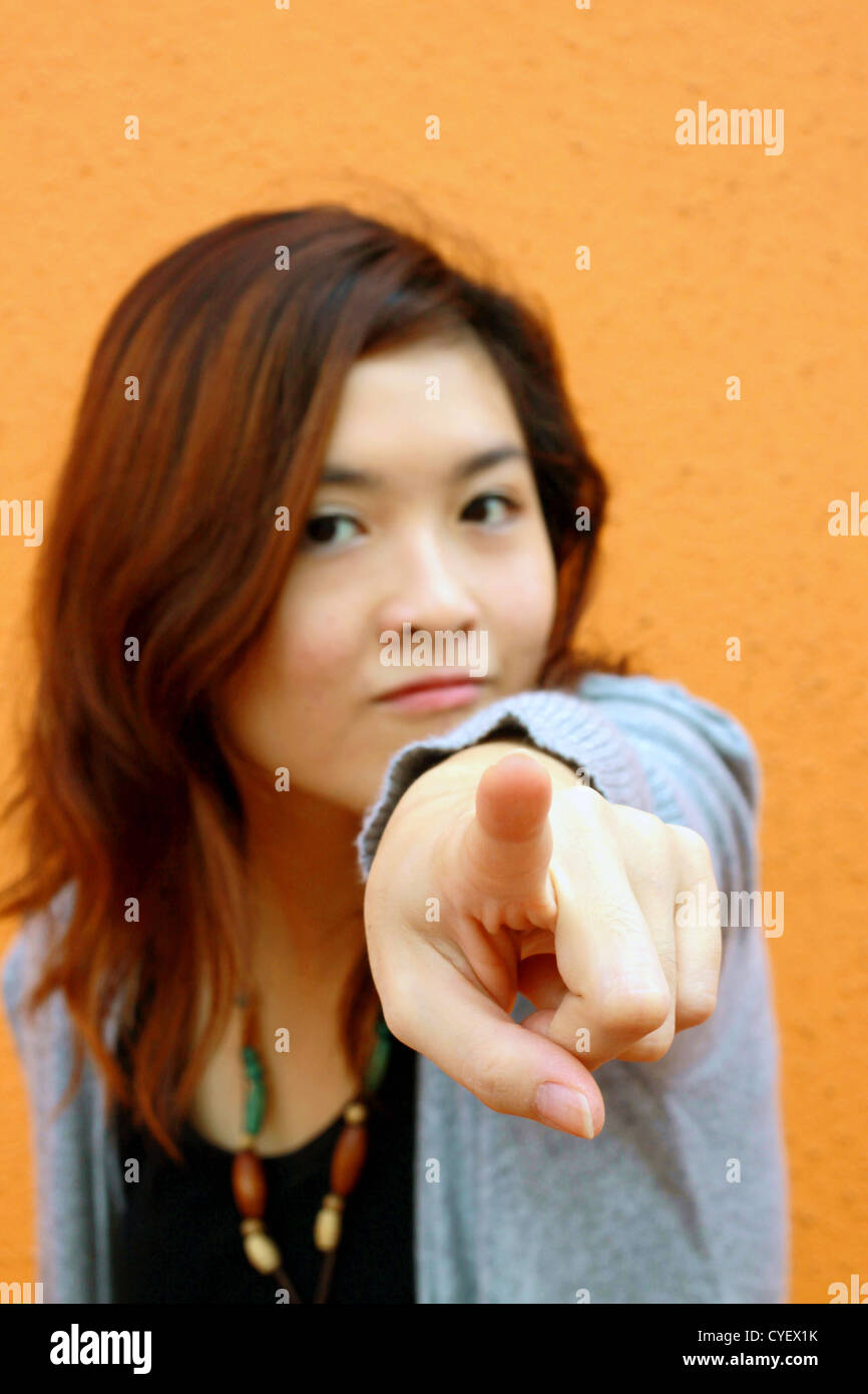 Asian woman pointing Stock Photo - Alamy