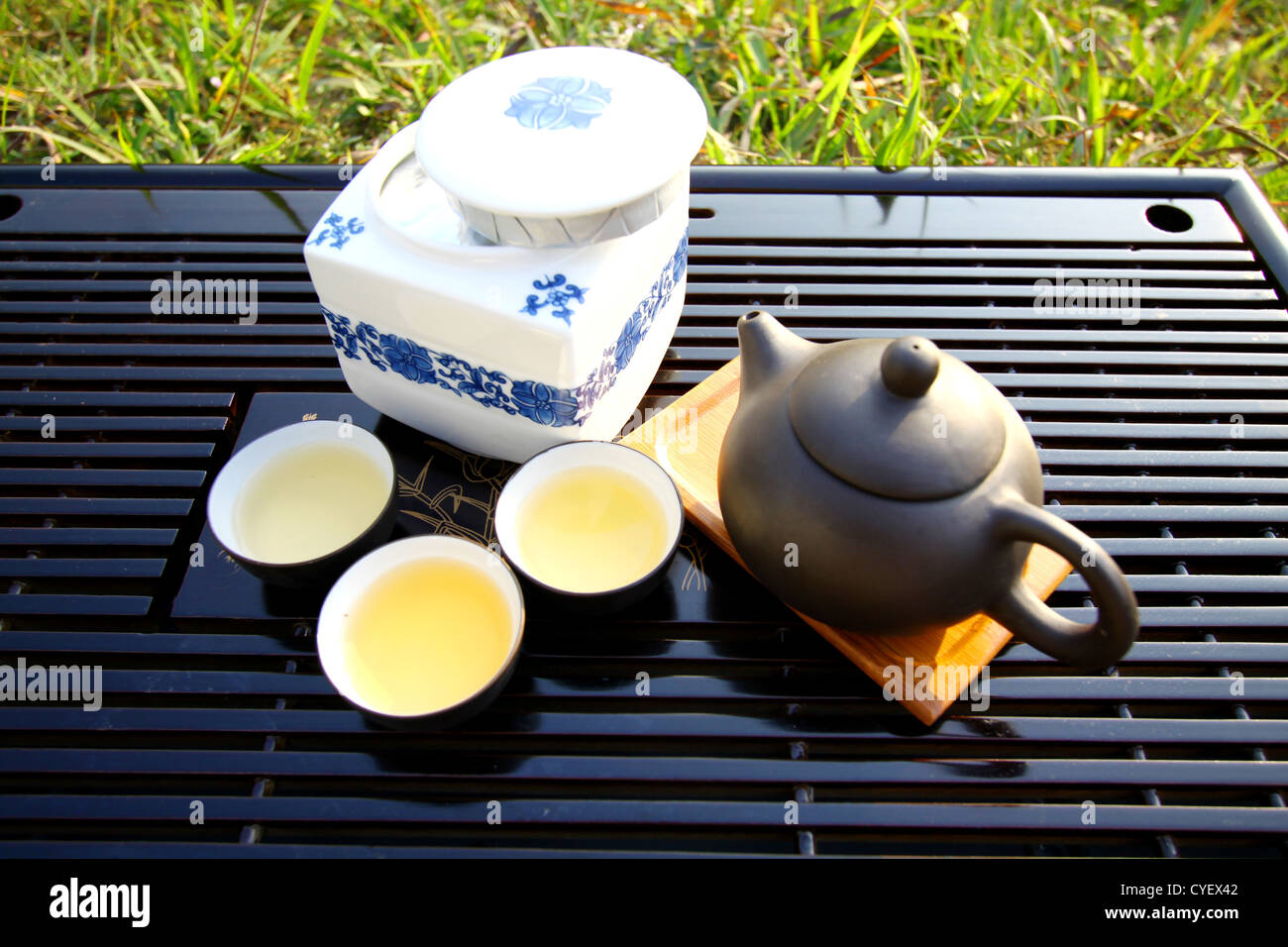 Asian tea set on grasses Stock Photo - Alamy