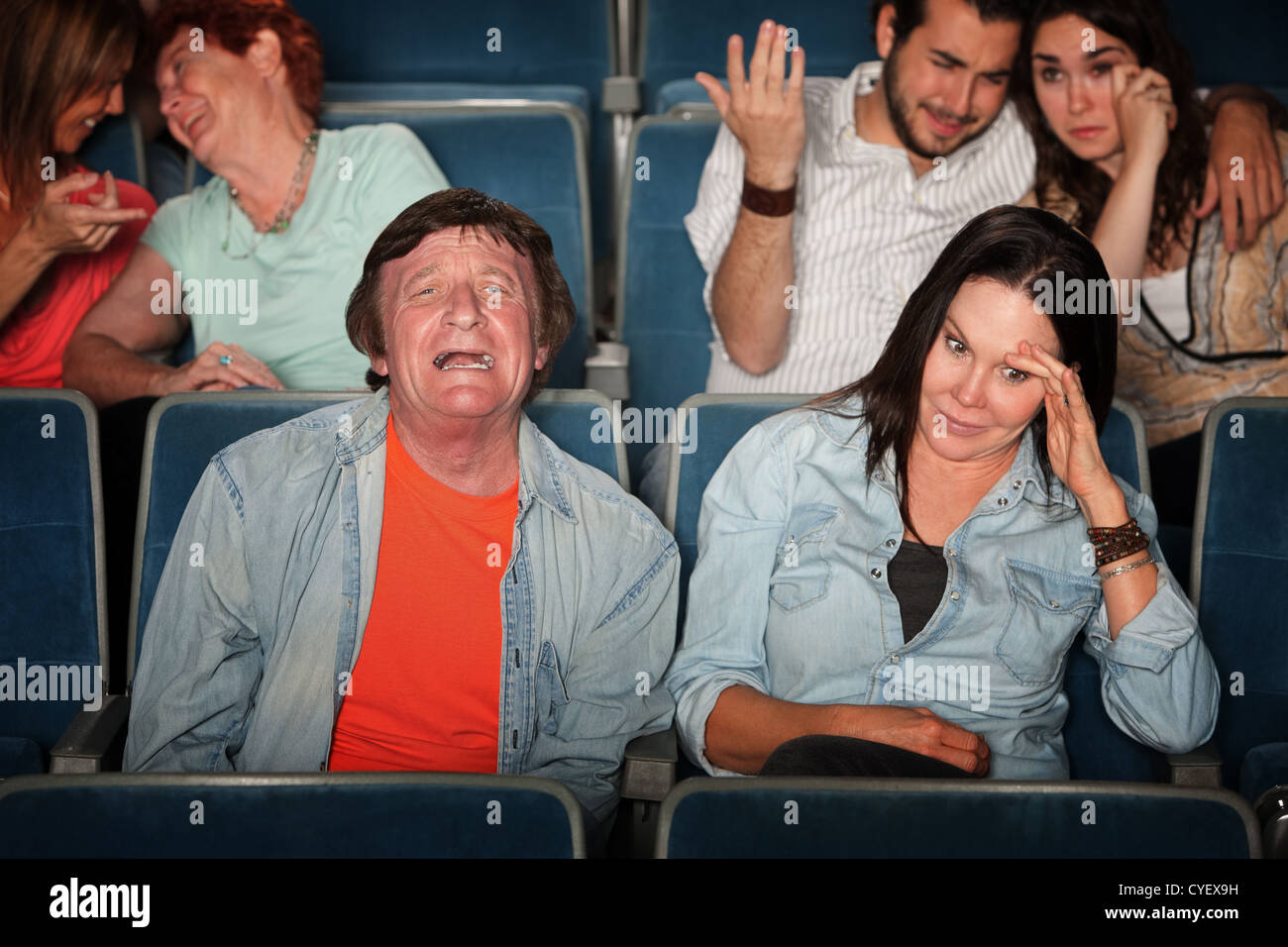Groups of weeping and embarrassed people in a theater Stock Photo - Alamy