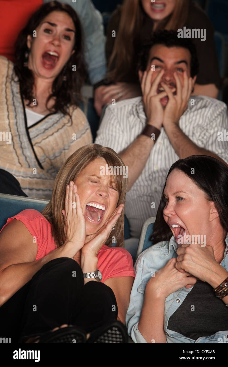 Scared group of spectators in theater seats scream in fear Stock Photo ...