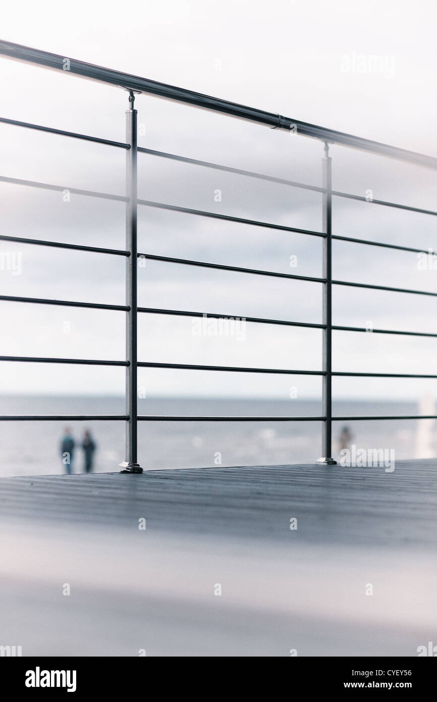 Walking on the beach by the sea through the railing at home Stock Photo ...