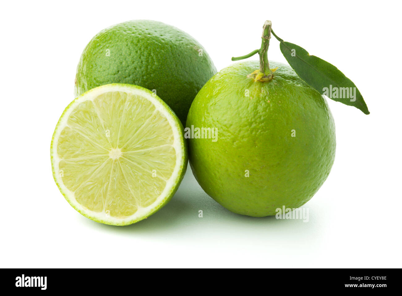 Ripe limes with green leaf. Isolated on white Stock Photo - Alamy